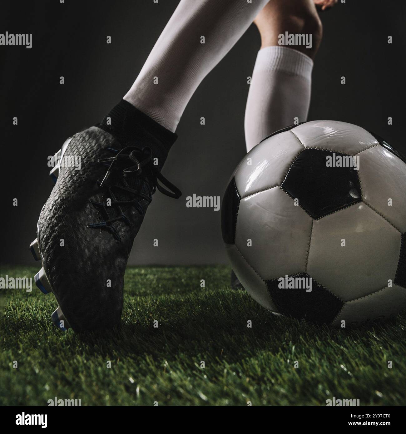 Close up leg kicking ball Stock Photo - Alamy