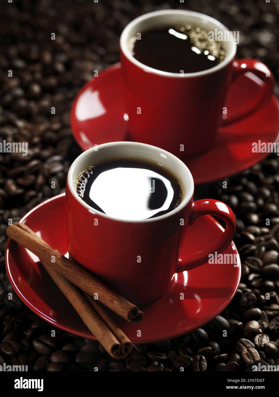 Two red cups of coffee on coffe beans background Stock Photo - Alamy