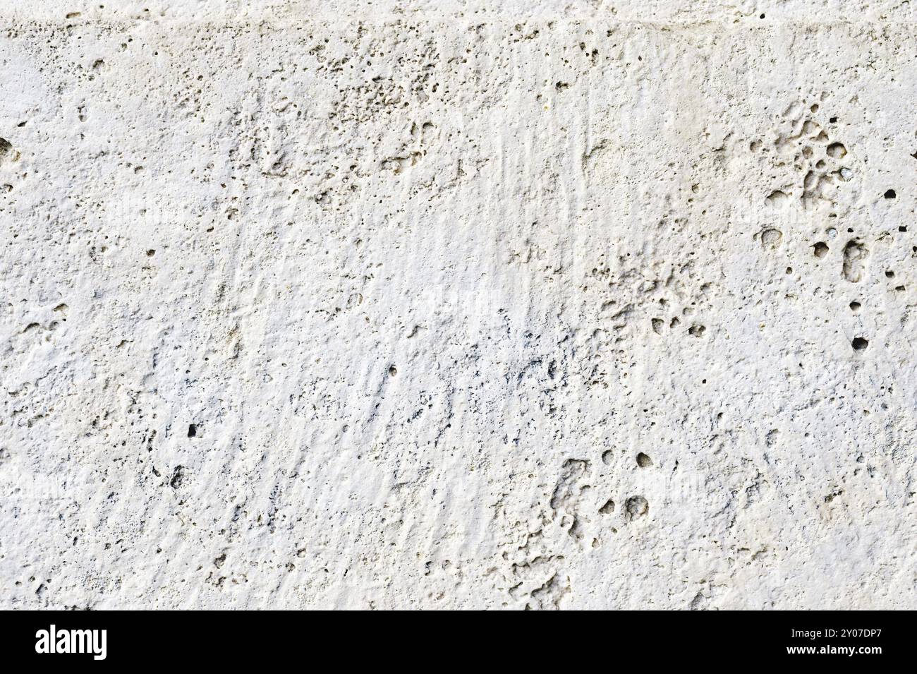 Close-up Deep texture of white-painted porous stone on the facade of ...