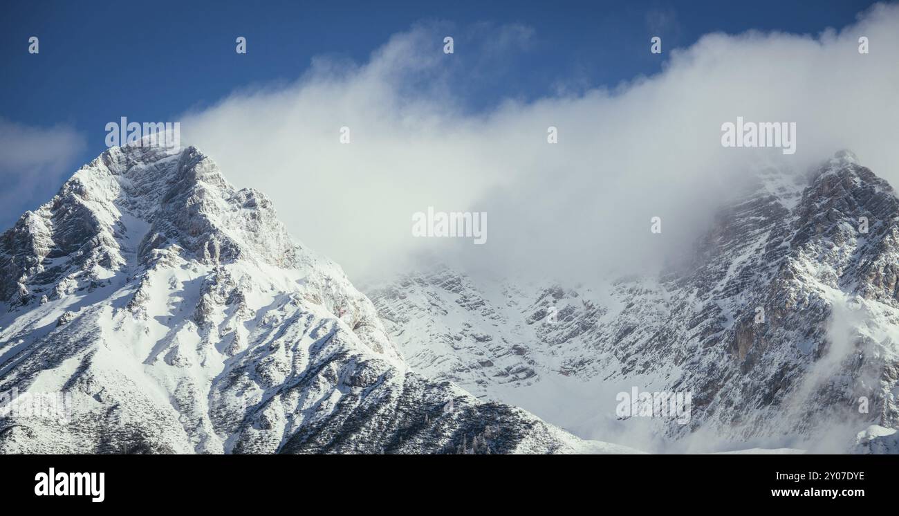 Epic snowy mountain peak with clouds in winter, landscape, alps ...
