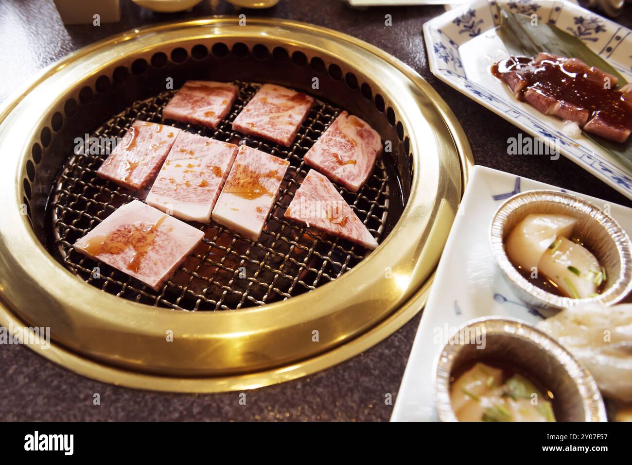 Beef being cooked on a grill stove at a Japanese restaurant. Yakiniku ...
