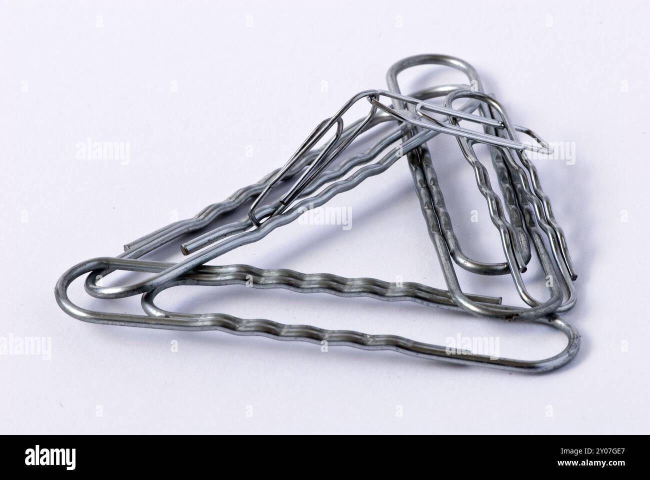Triangle made from paper clips Stock Photo - Alamy