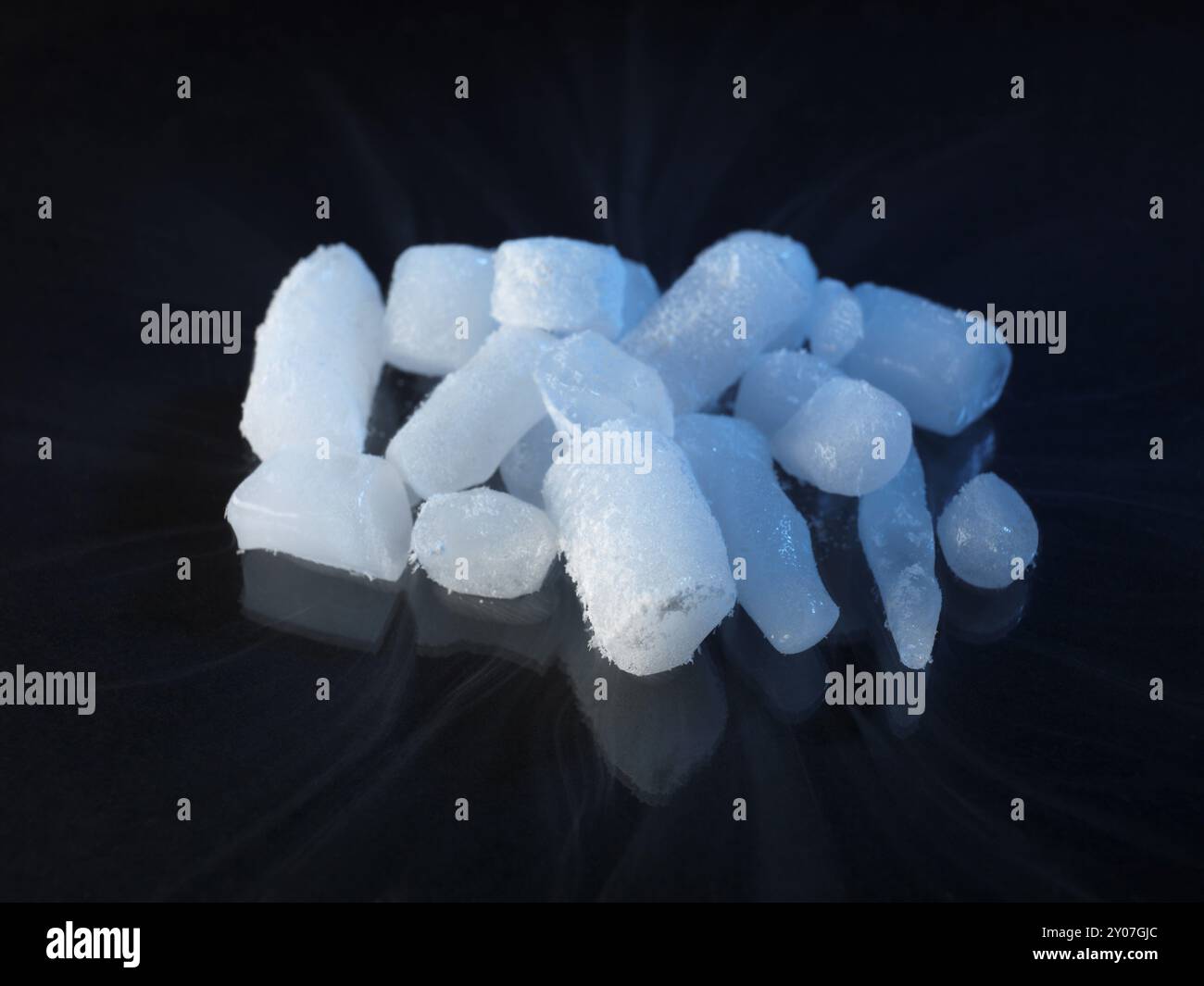 Dry Ice nuggets sublimating in room temperature. Isolated on black ...