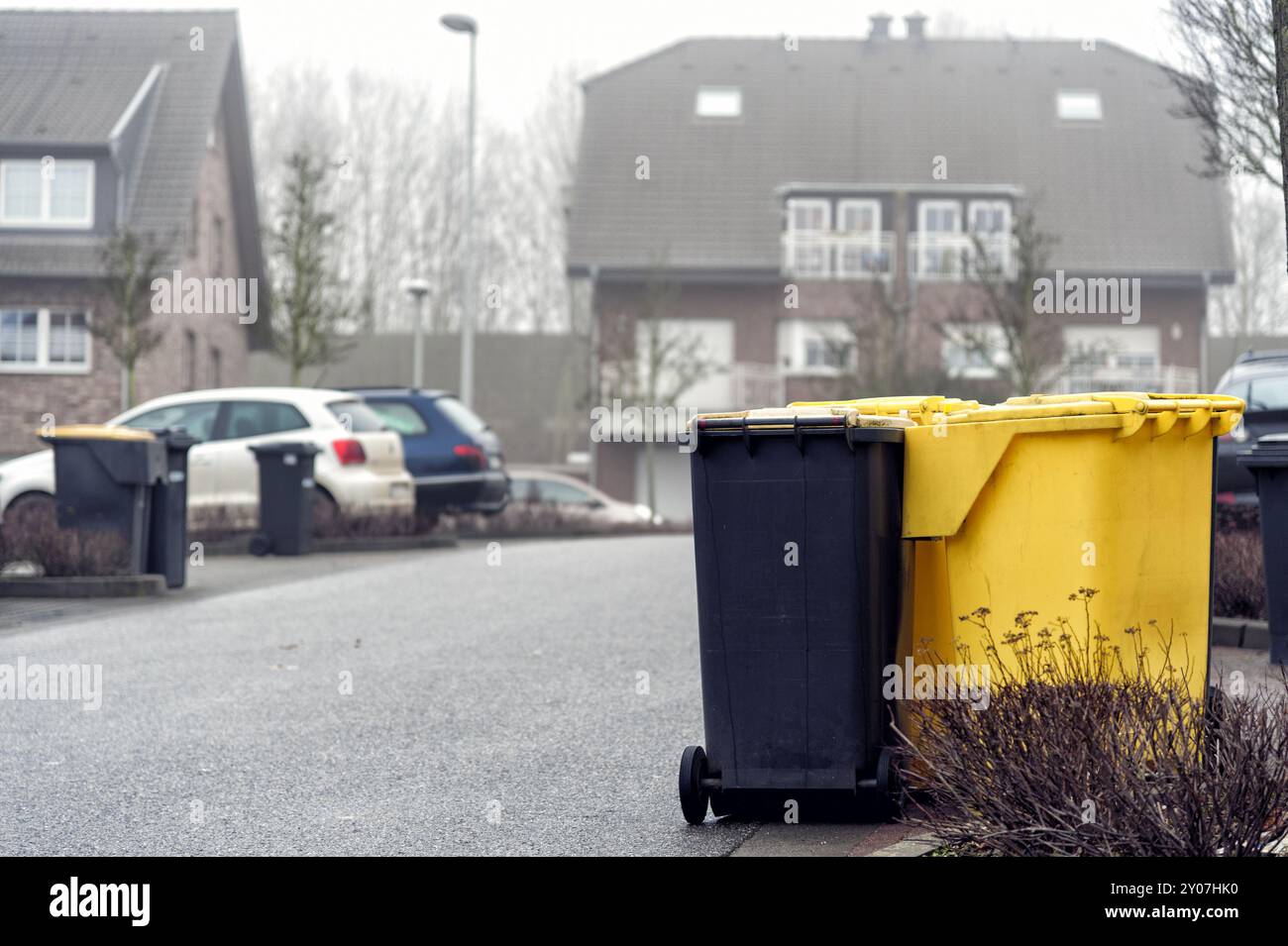 Yellow and grey bins in a residential area Stock Photo - Alamy