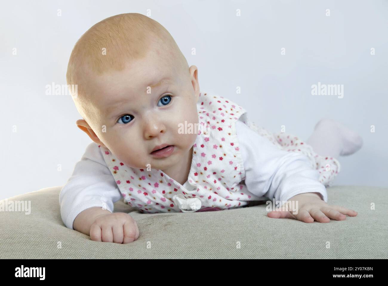Infant lying on its stomach, front view Stock Photo - Alamy