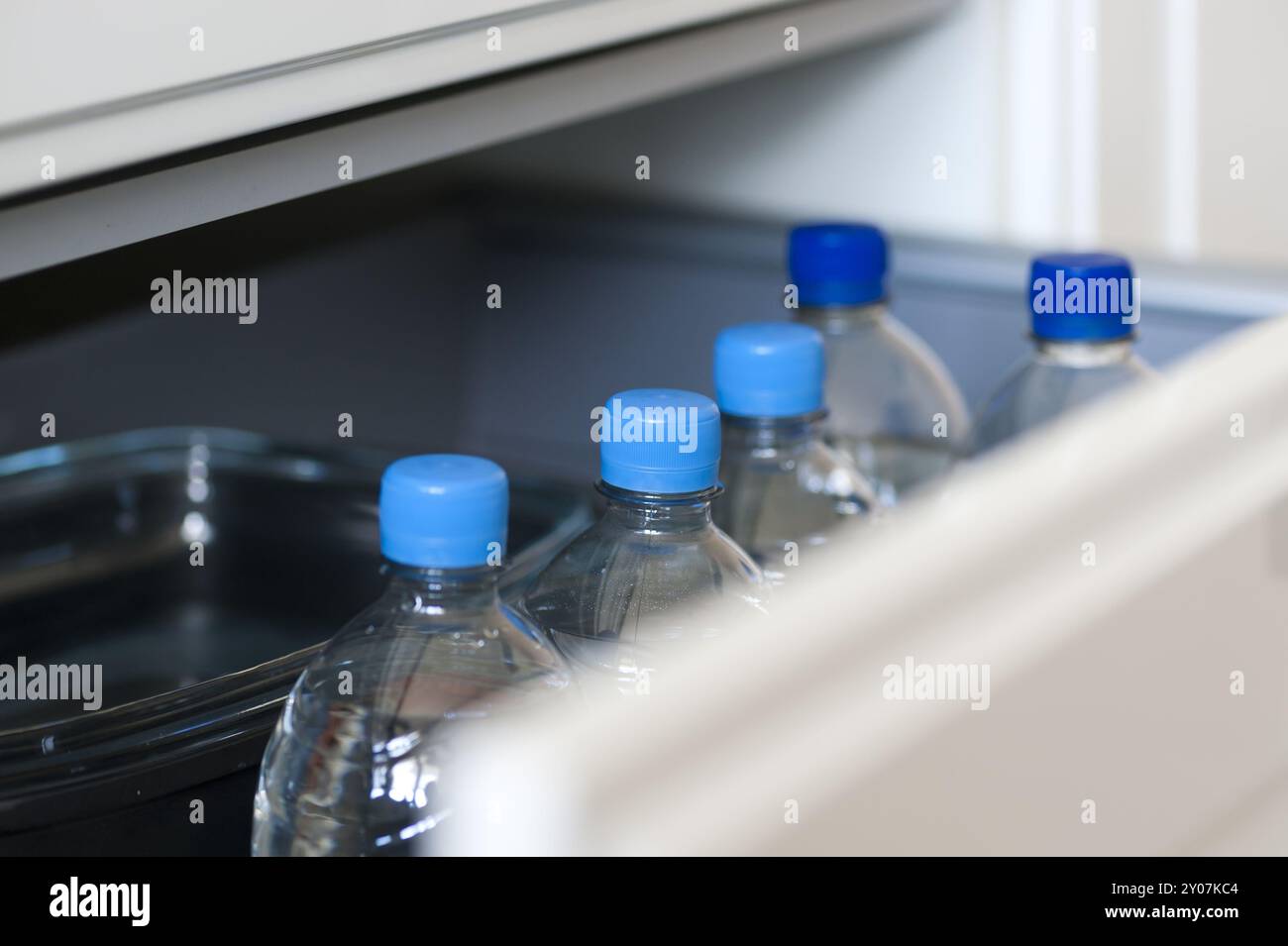 Open roller cabinet with water bottles Stock Photo - Alamy