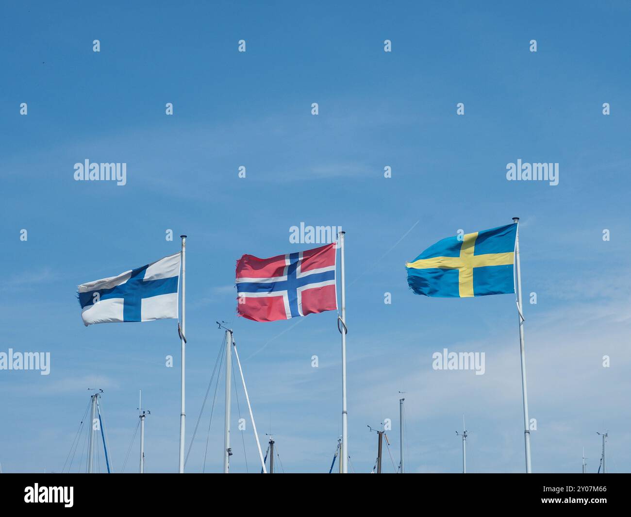 Three Scandinavian flags in a marina on a blue summer sky Stock Photo ...