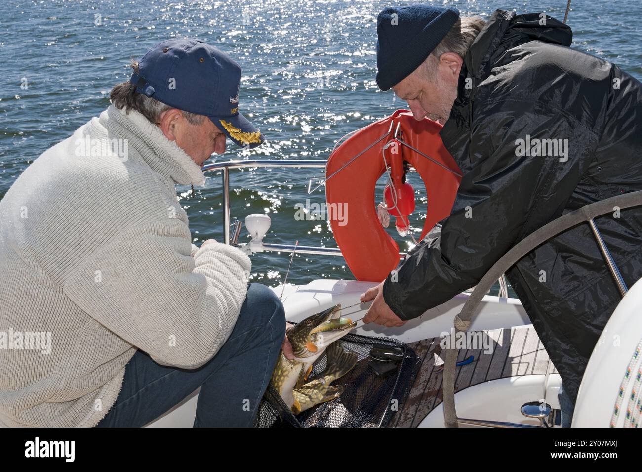 Deep-sea angler with a freshly caught pike Stock Photo - Alamy