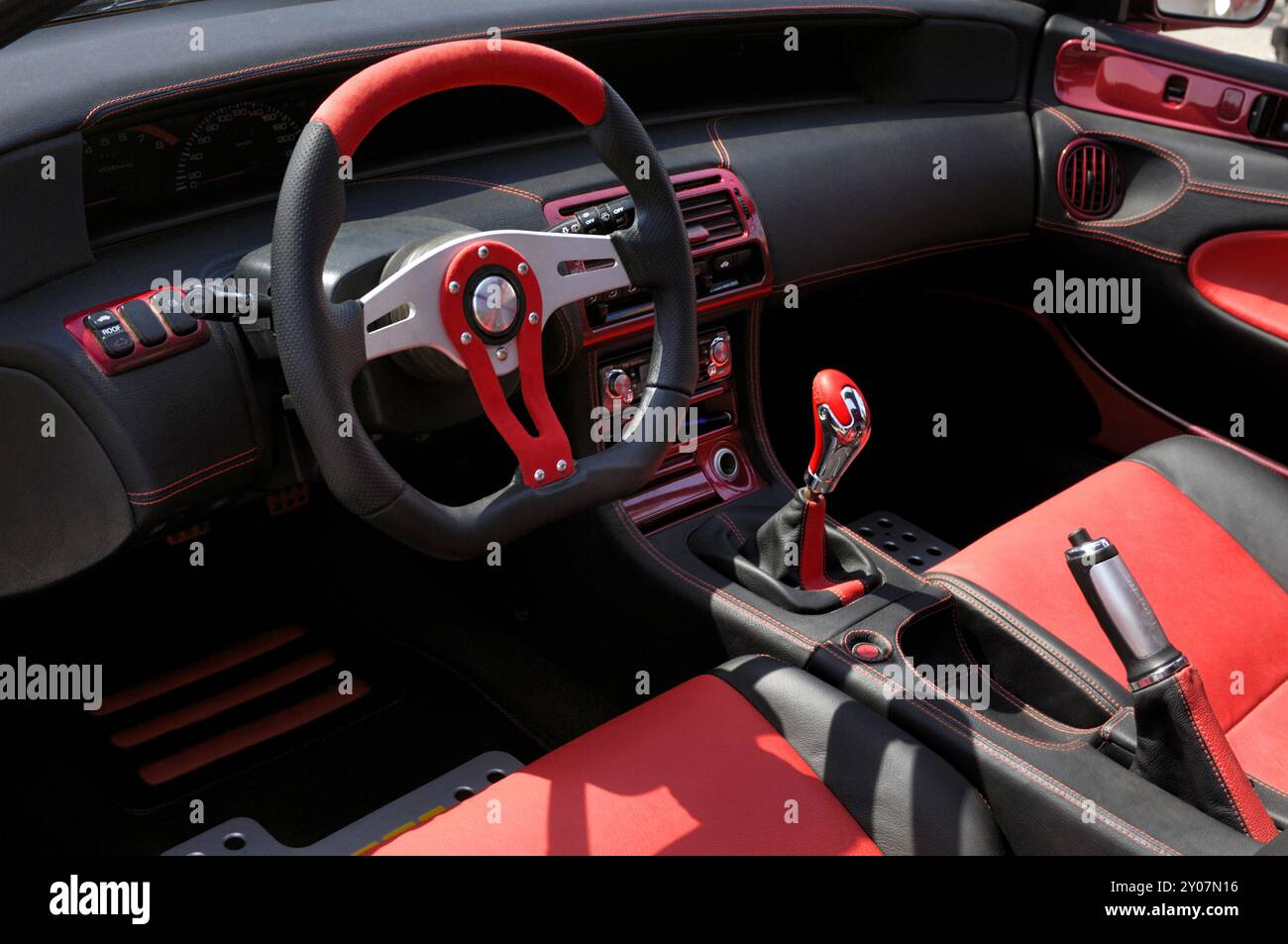 Red and black leather interior of a custom sports race car with ...
