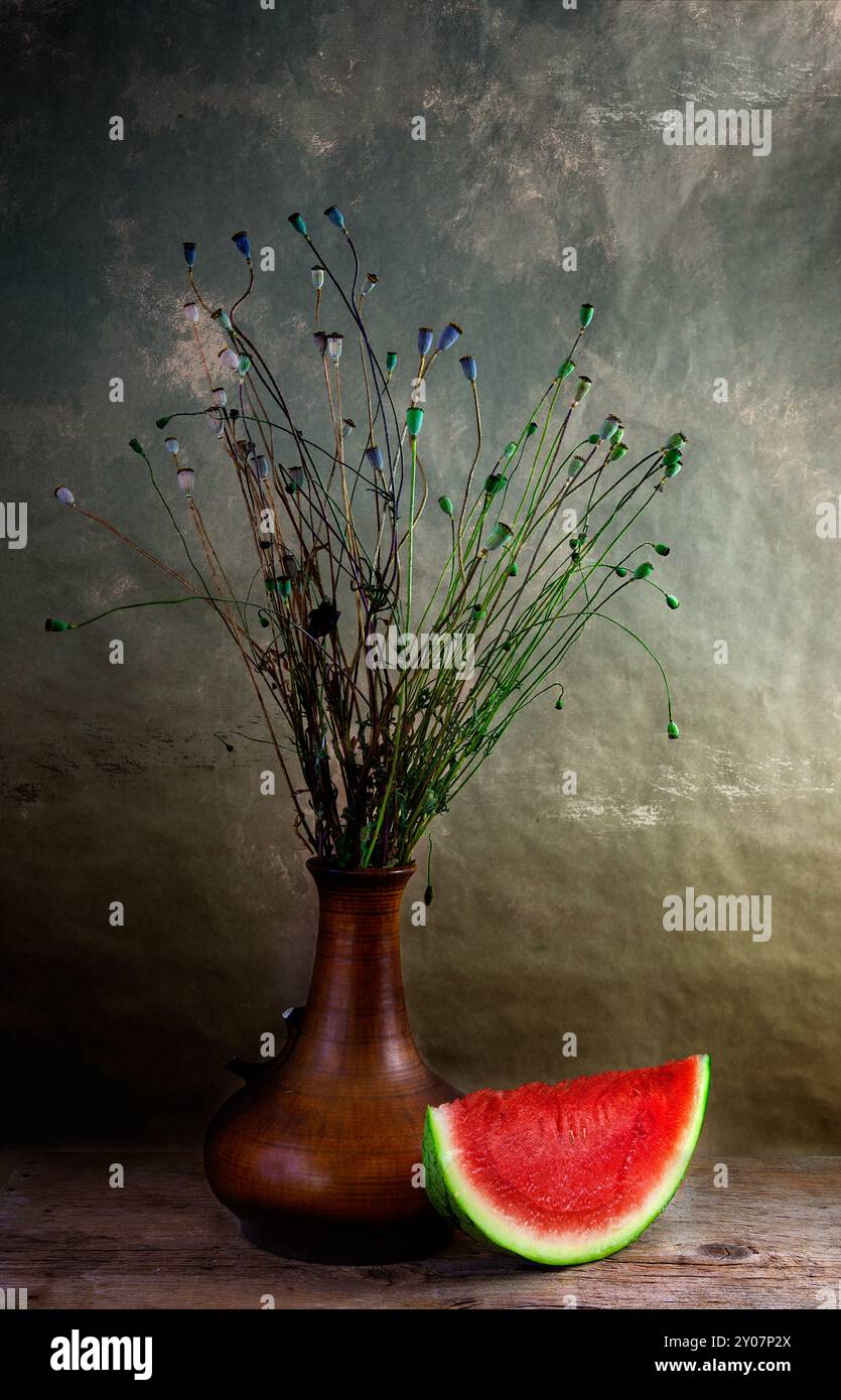Still life with poppy capsules and watermelon Stock Photo - Alamy