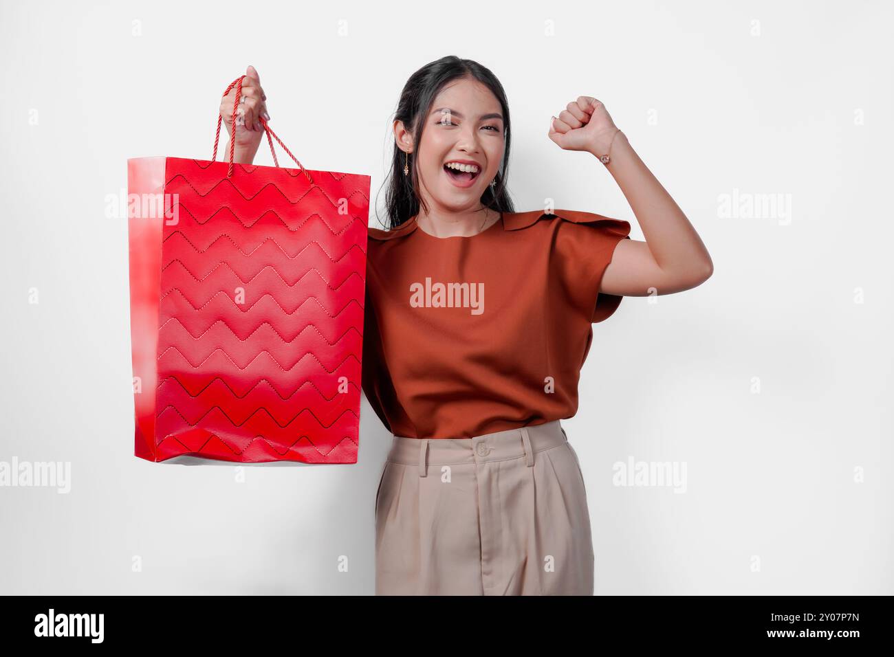 Excited woman is holding a red shopping bag with happy successful ...