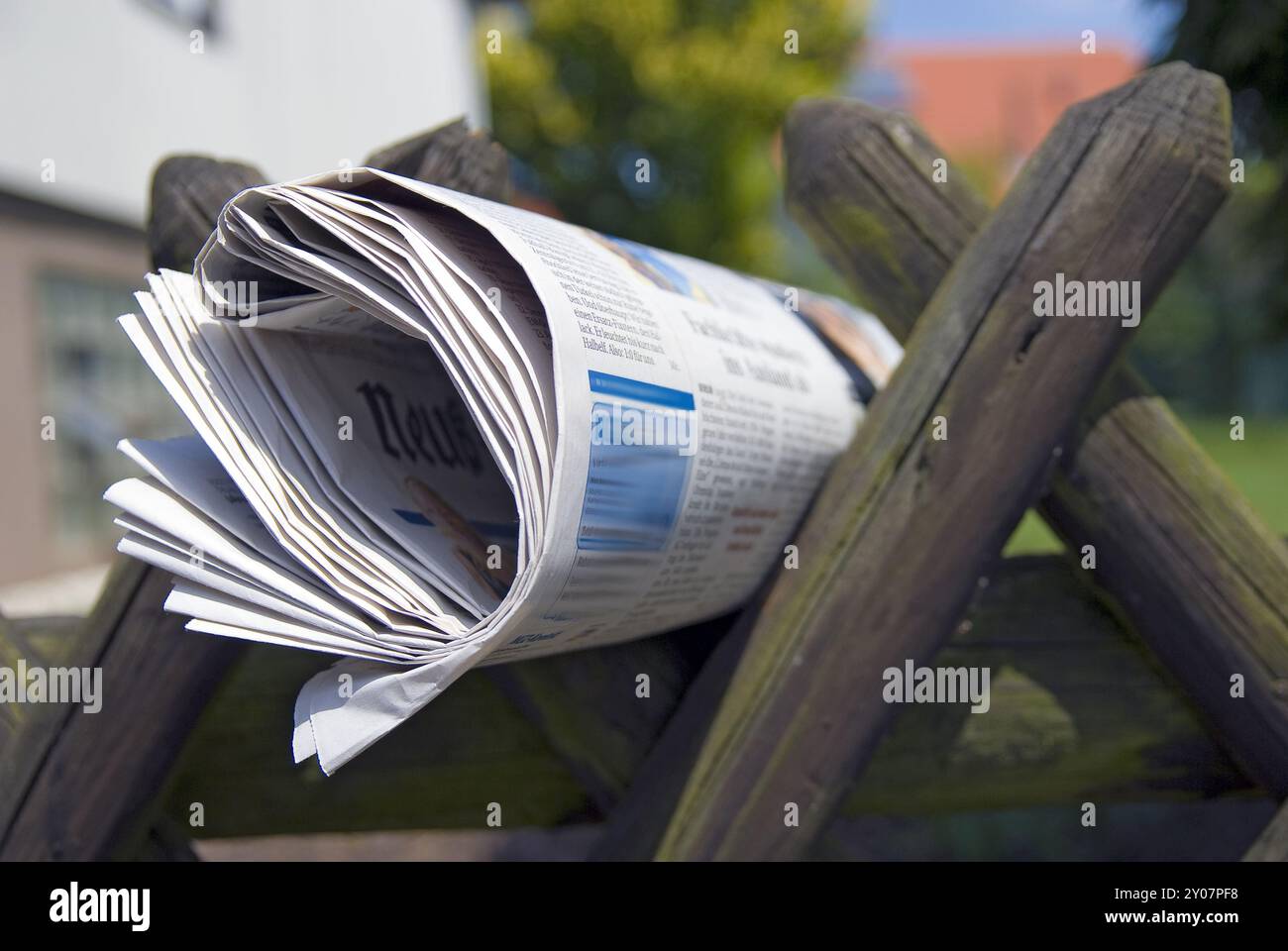 Newspaper at the garden fence Stock Photo - Alamy