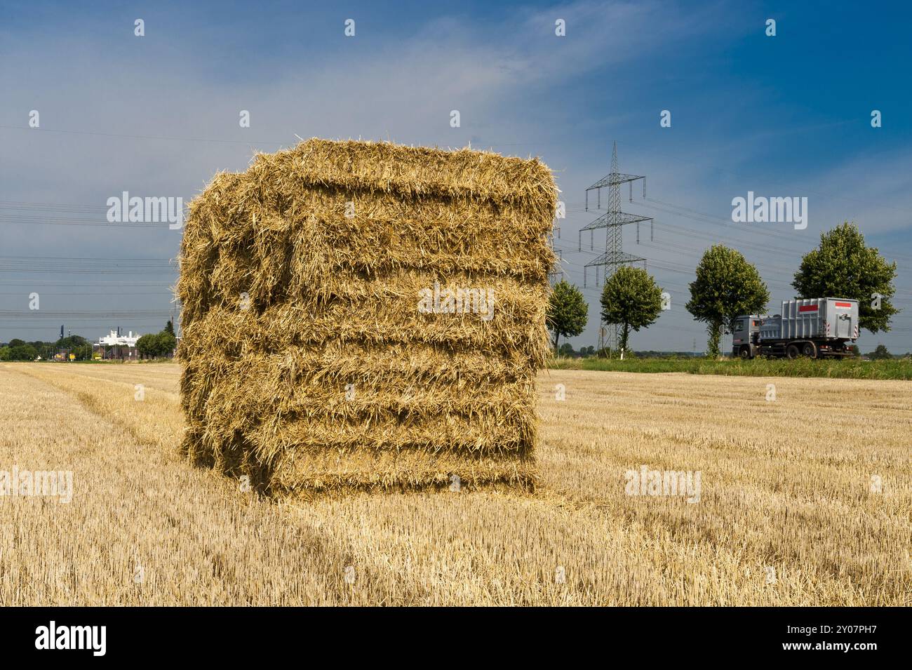 Straw stack on a stubble field in the sunshine Stock Photo - Alamy
