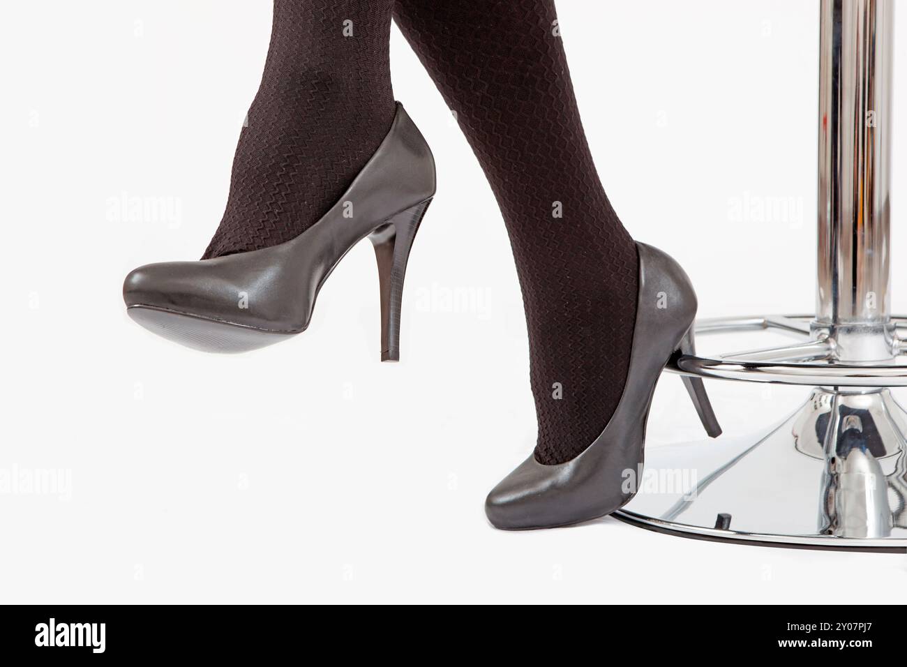 Woman sitting on a bar stool Stock Photo - Alamy