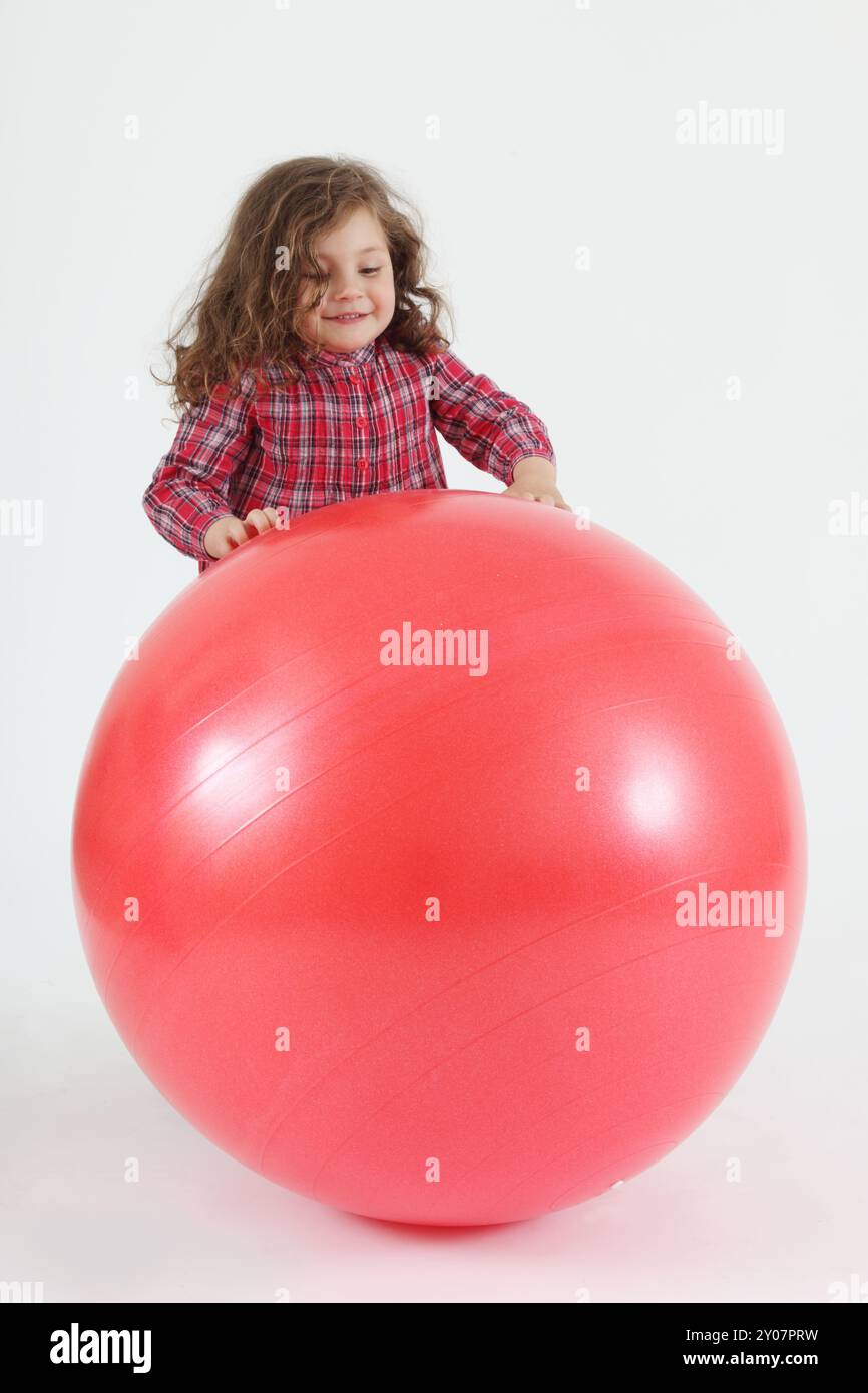 Child playing with a large sitting ball Stock Photo - Alamy