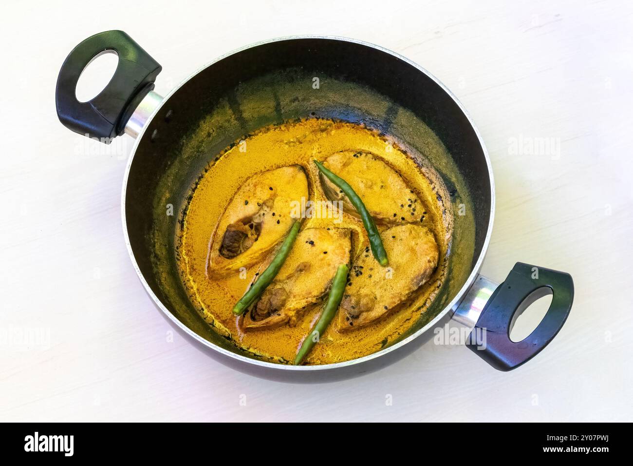Traditional Bengali dish shorshe ilish in a nonstick pan. It's a ...