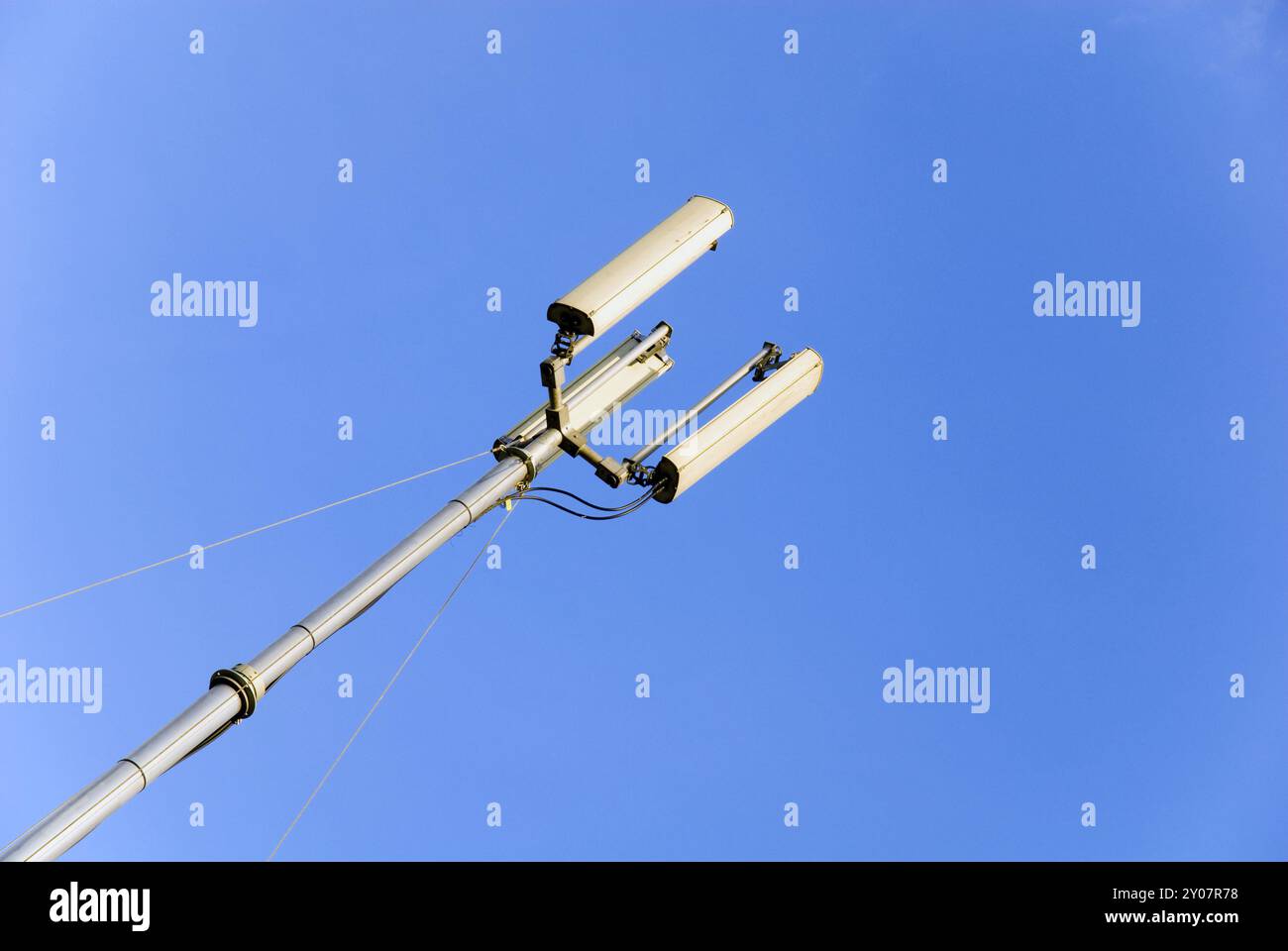Mobile phone mast in front of a blue sky Stock Photo - Alamy