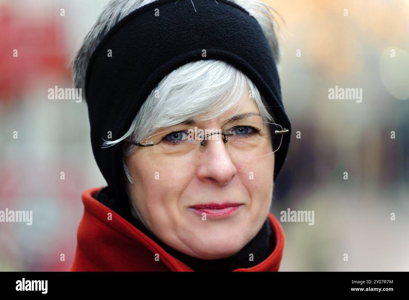Woman looks camera smiles turns hi-res stock photography and images - Alamy