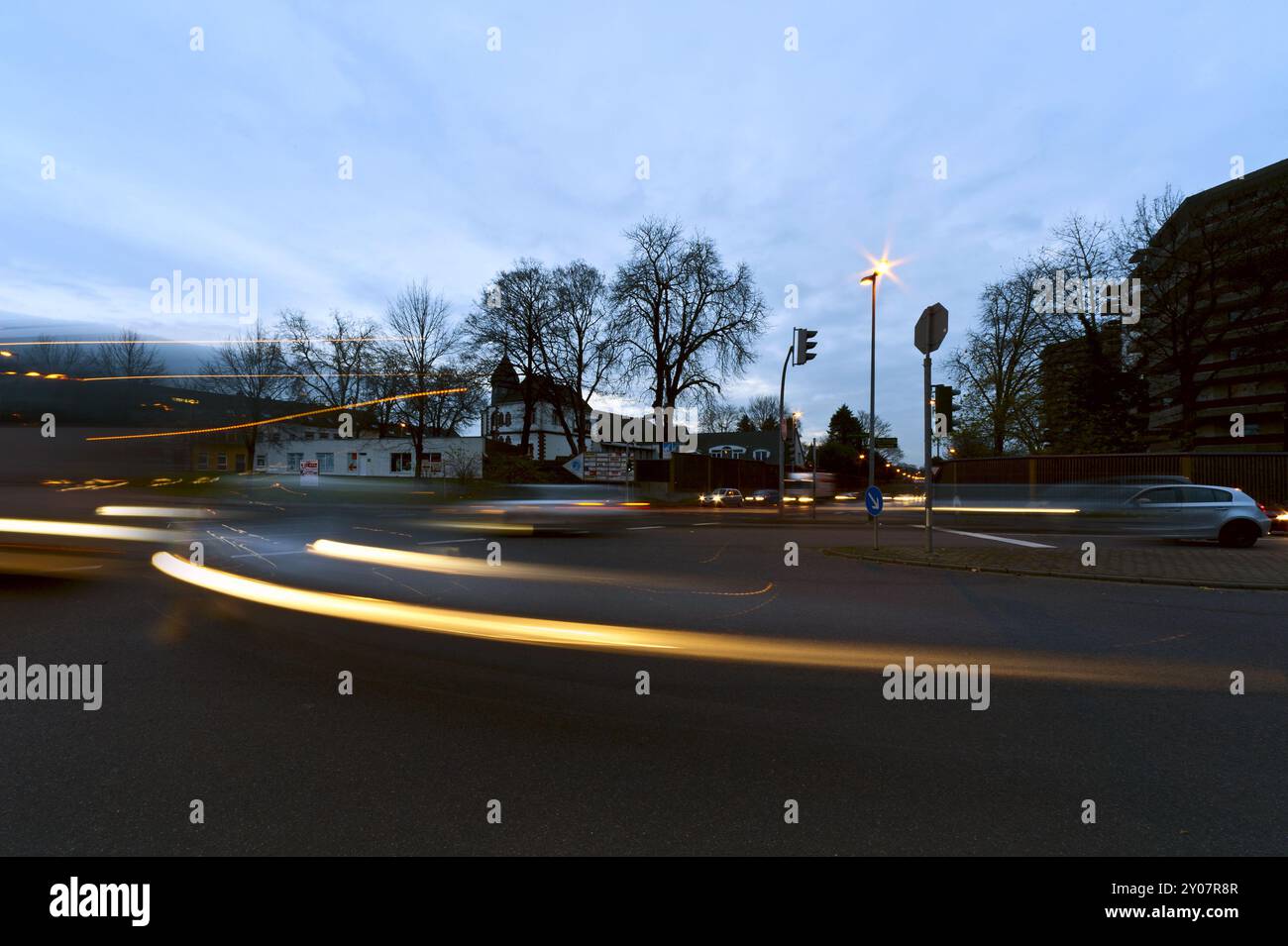 Busy road junction at dusk Stock Photo - Alamy