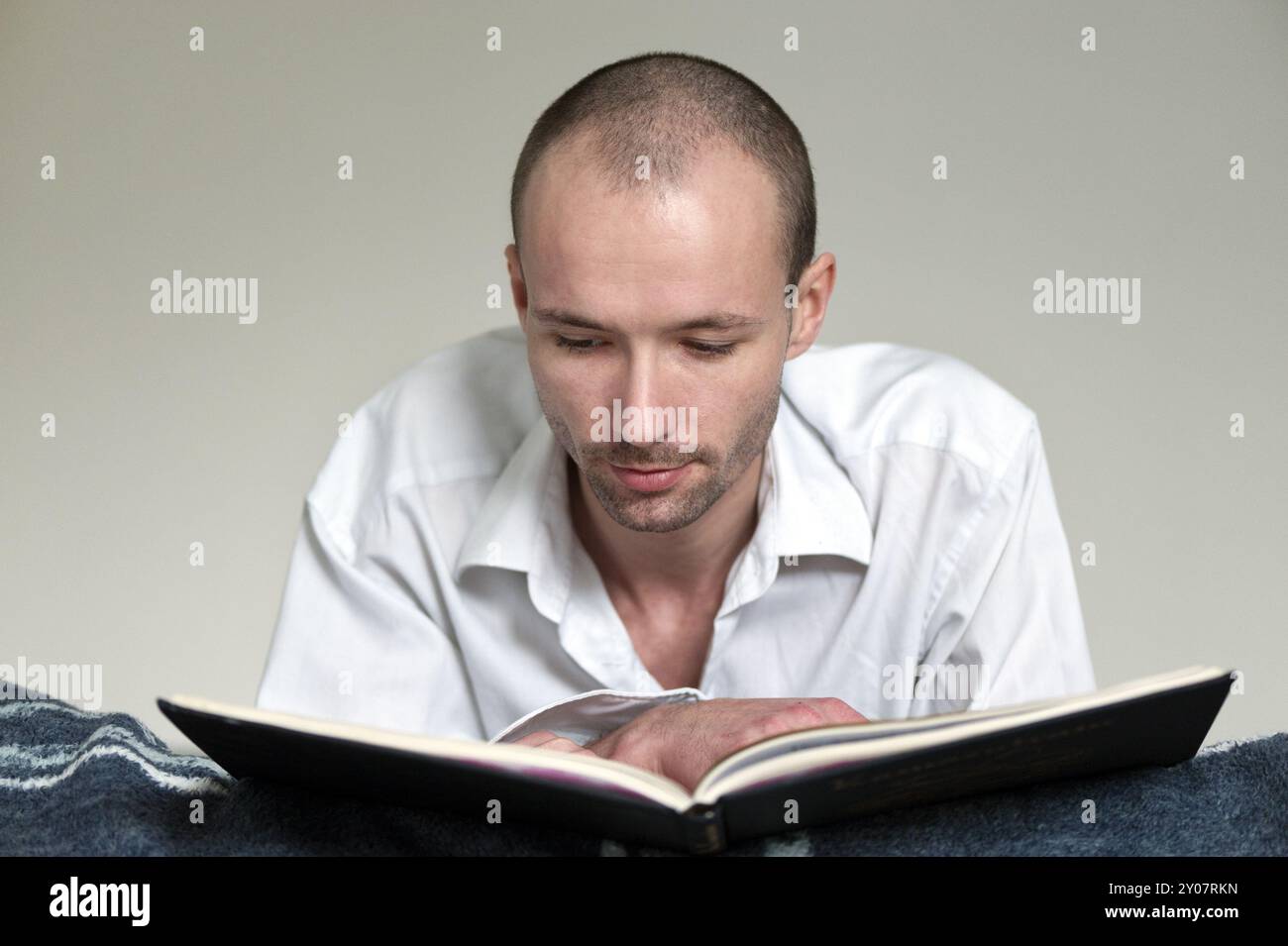 Young guy lies on bed hi-res stock photography and images - Alamy
