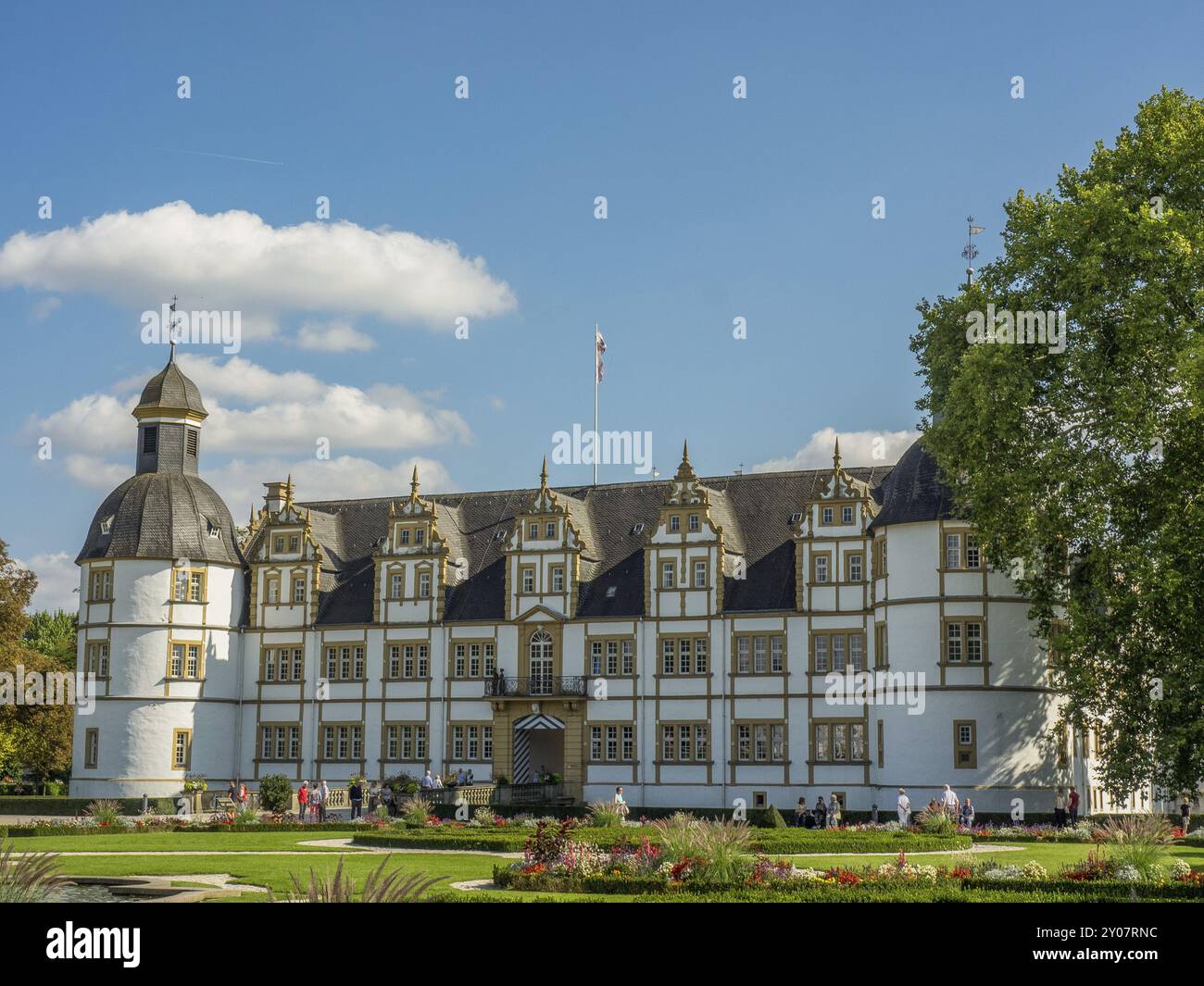 A magnificent castle with many windows, a well-tended garden and ...