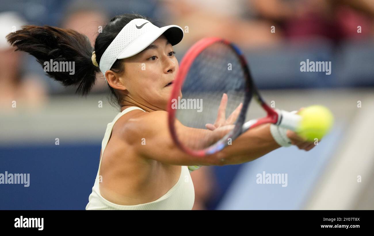 Yafan Wang, of China, returns a shot to Paula Badosa, of Spain, during ...