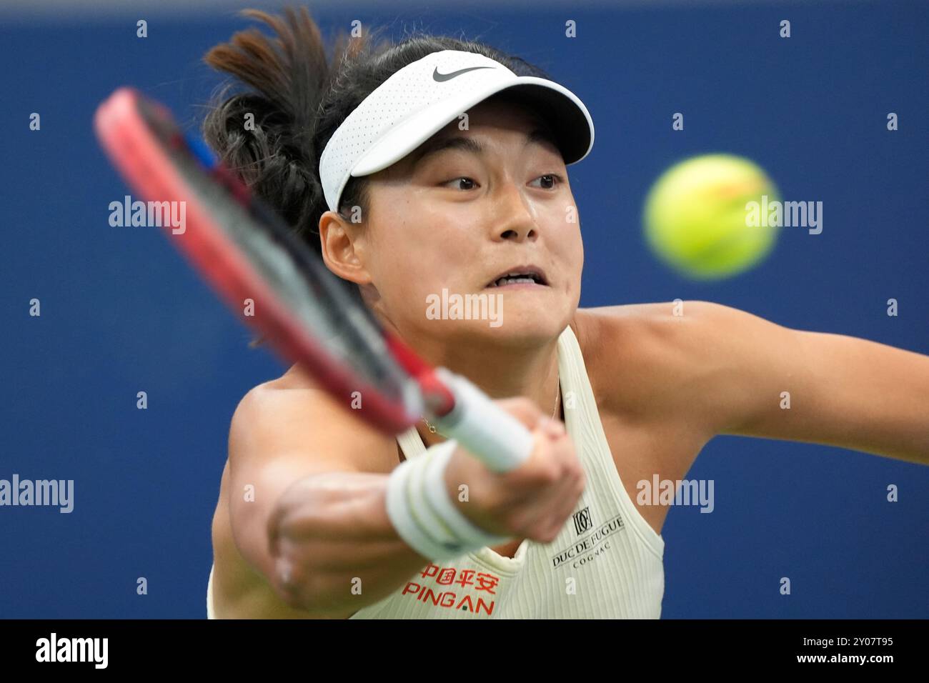 Yafan Wang, of China, returns a shot to Paula Badosa, of Spain, during ...