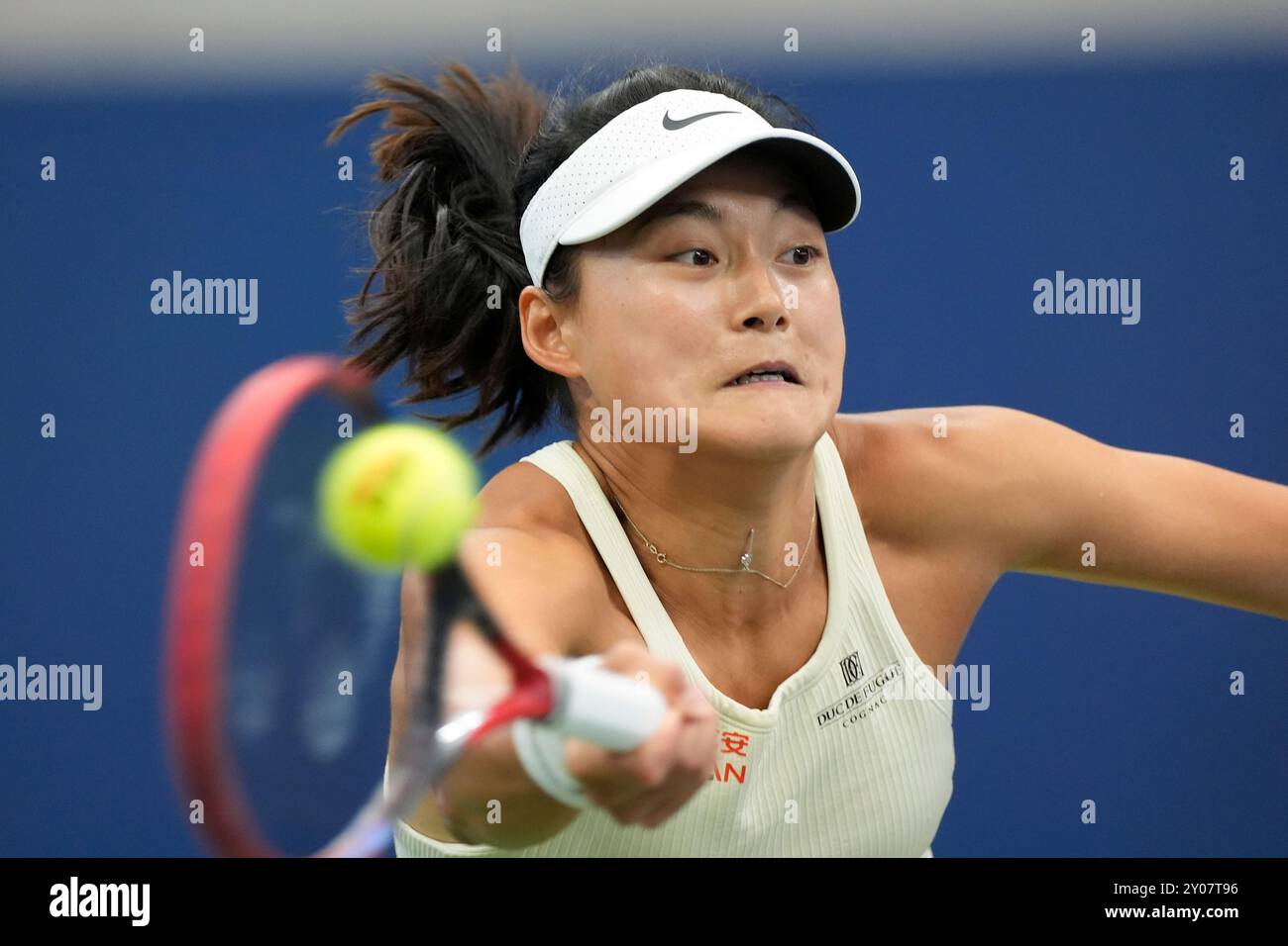 Yafan Wang, of China, returns a shot to Paula Badosa, of Spain, during ...