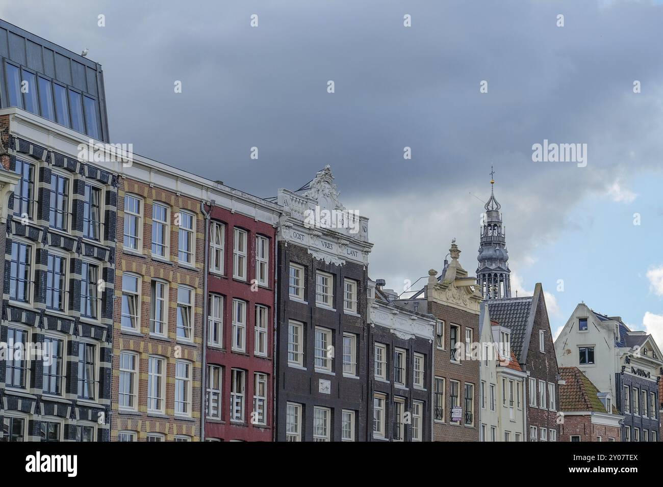 Historic buildings under a cloudy sky with a church tower in the ...