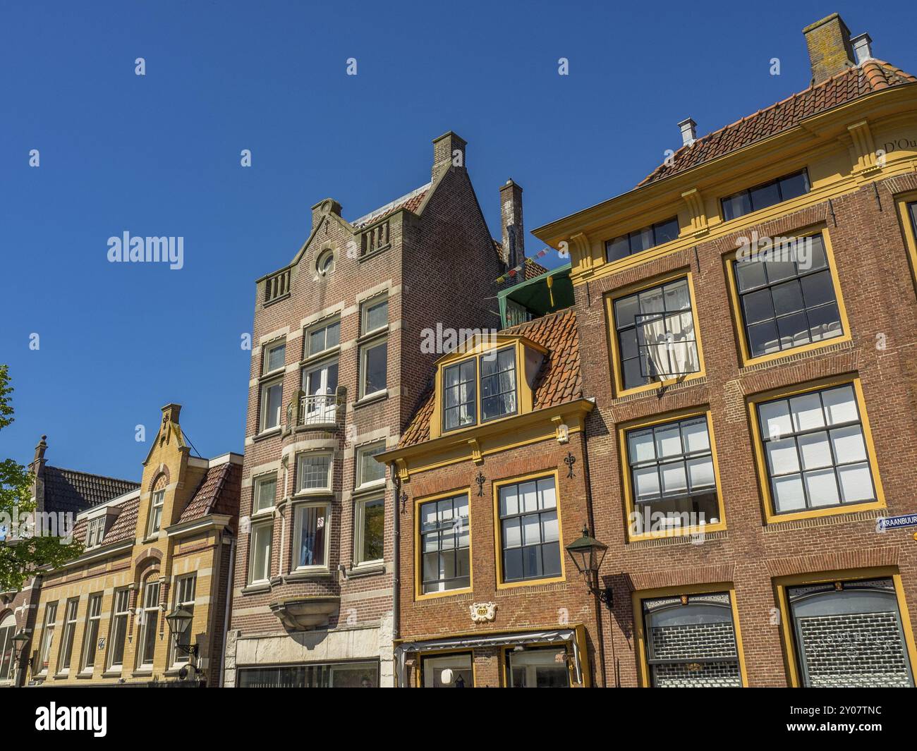 Row of historic buildings with striking facades and large windows under ...