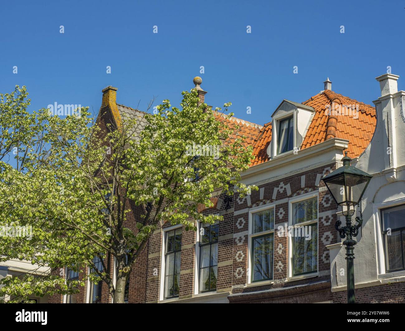 Traditional brick houses with decorative facades, windows and gabled ...
