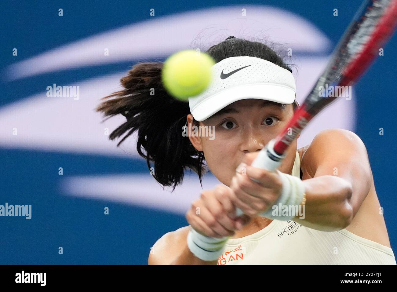 Yafan Wang, of China, returns a shot to Paula Badosa, of Spain, during ...