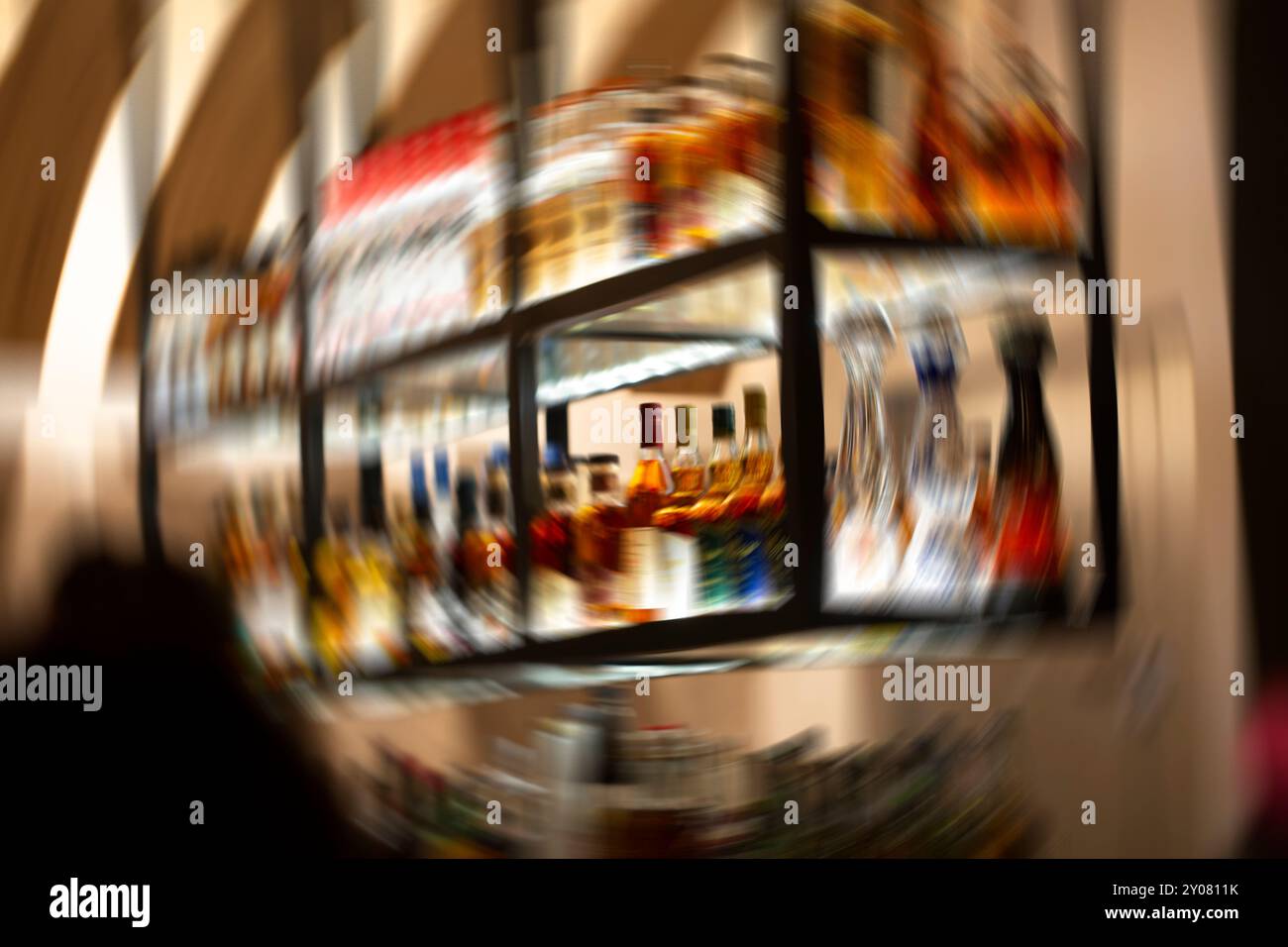 A view of liquor bottles display in a bar setting, featuring a drunken ...