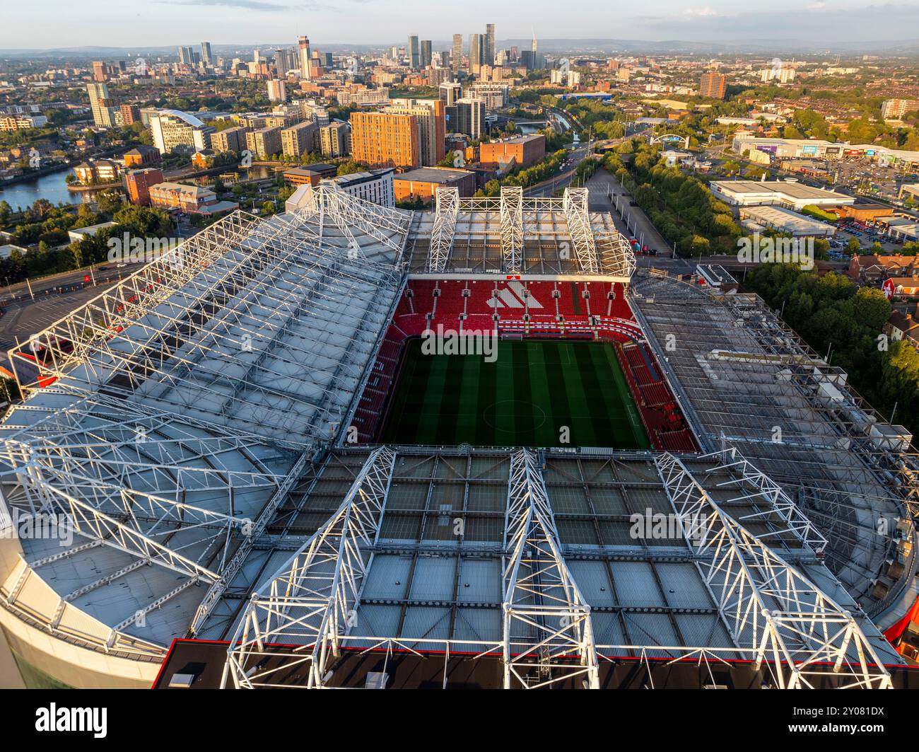 Old Trafford (Manchester United) stadium at sunset with the Manchester ...