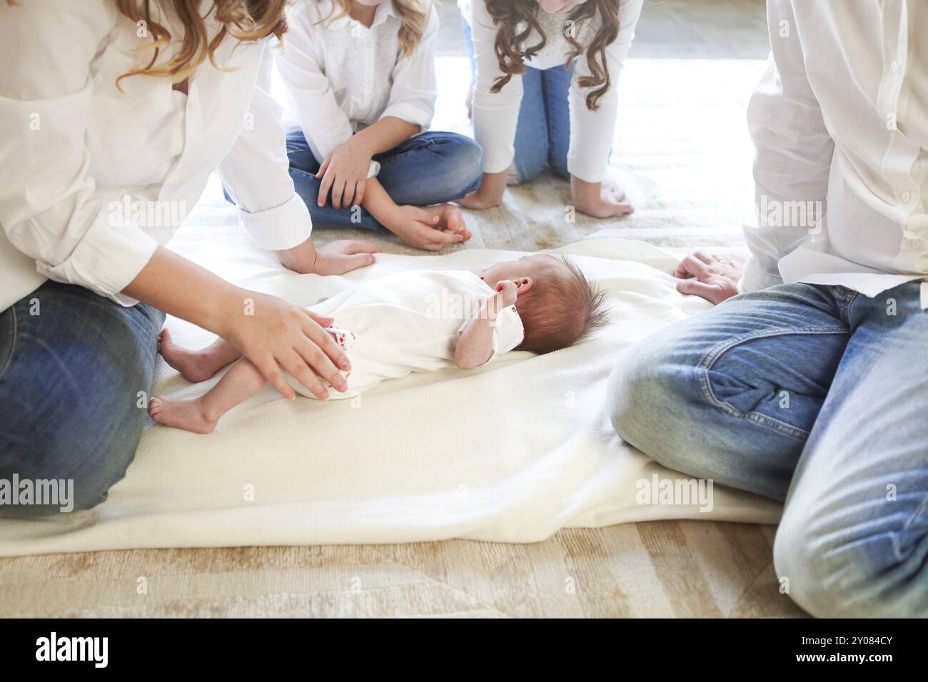 Big family with three kids in white living room. Parents and kids ...