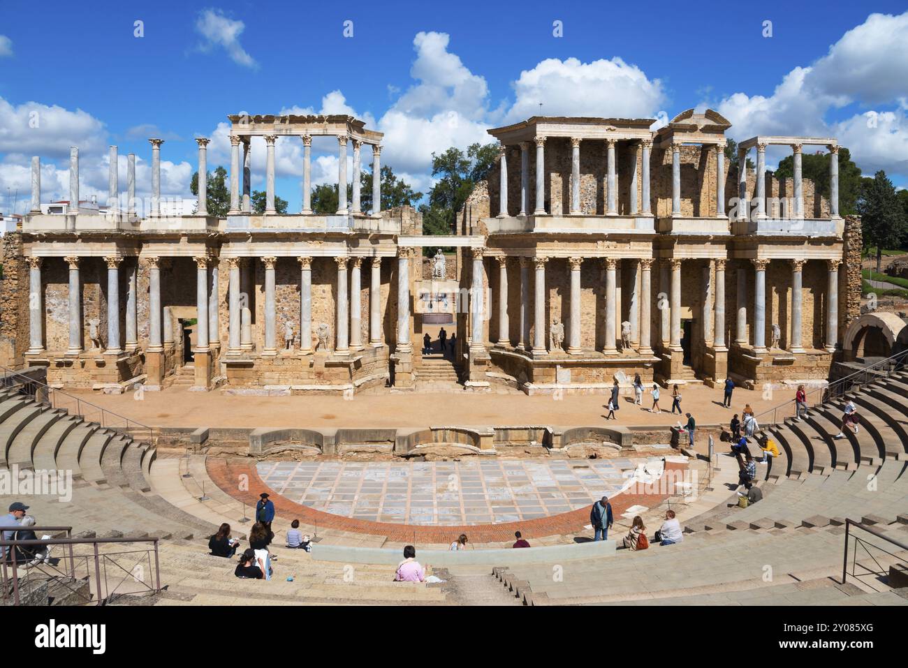 Ancient Roman theatre with ruins and columns in the background, people ...