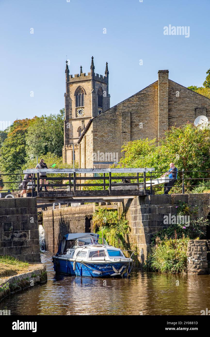 Pleasure craft boat on the Rochdale canal as it passes through locks on ...