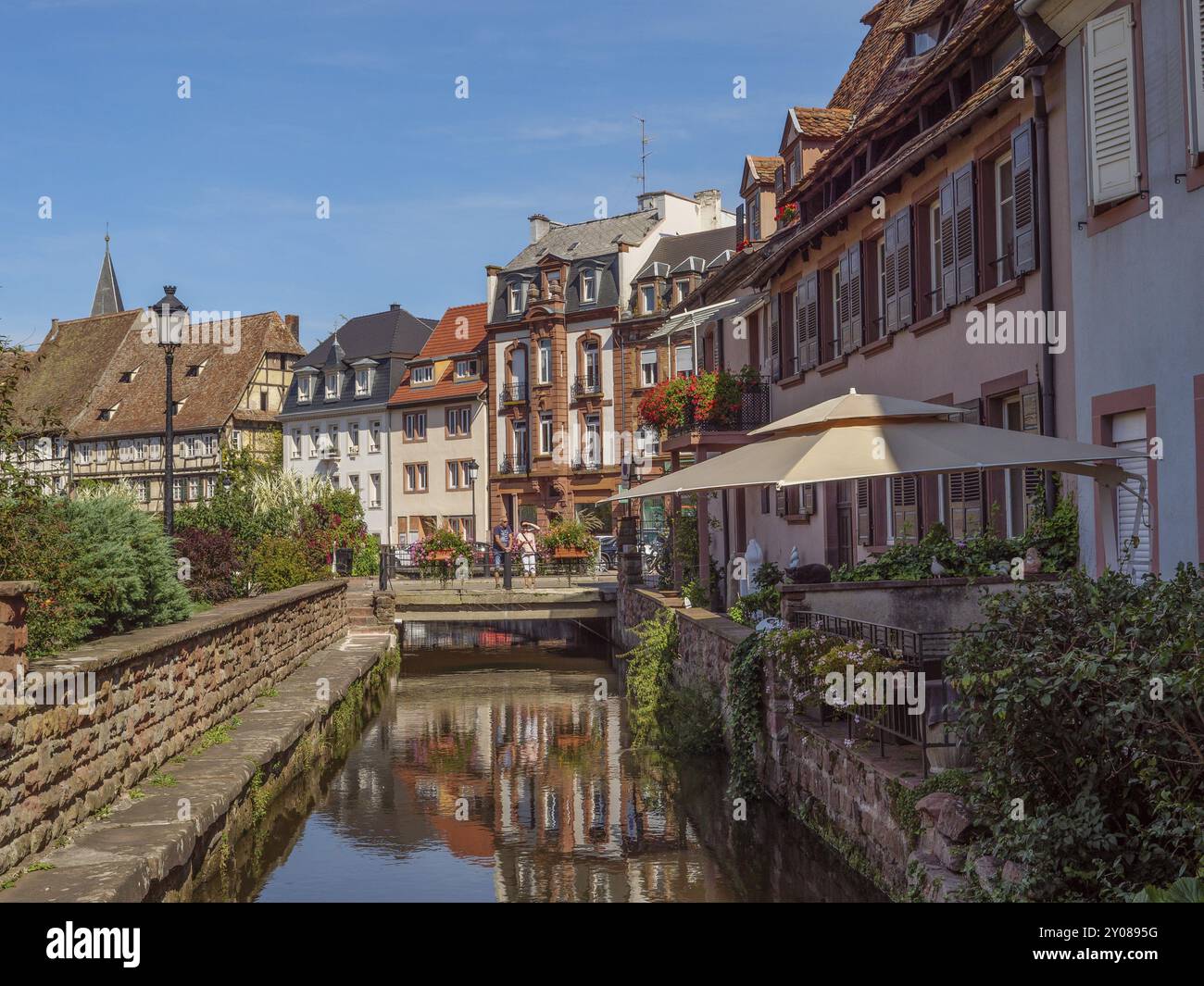A canal with historic half-timbered houses and picturesque bridges ...