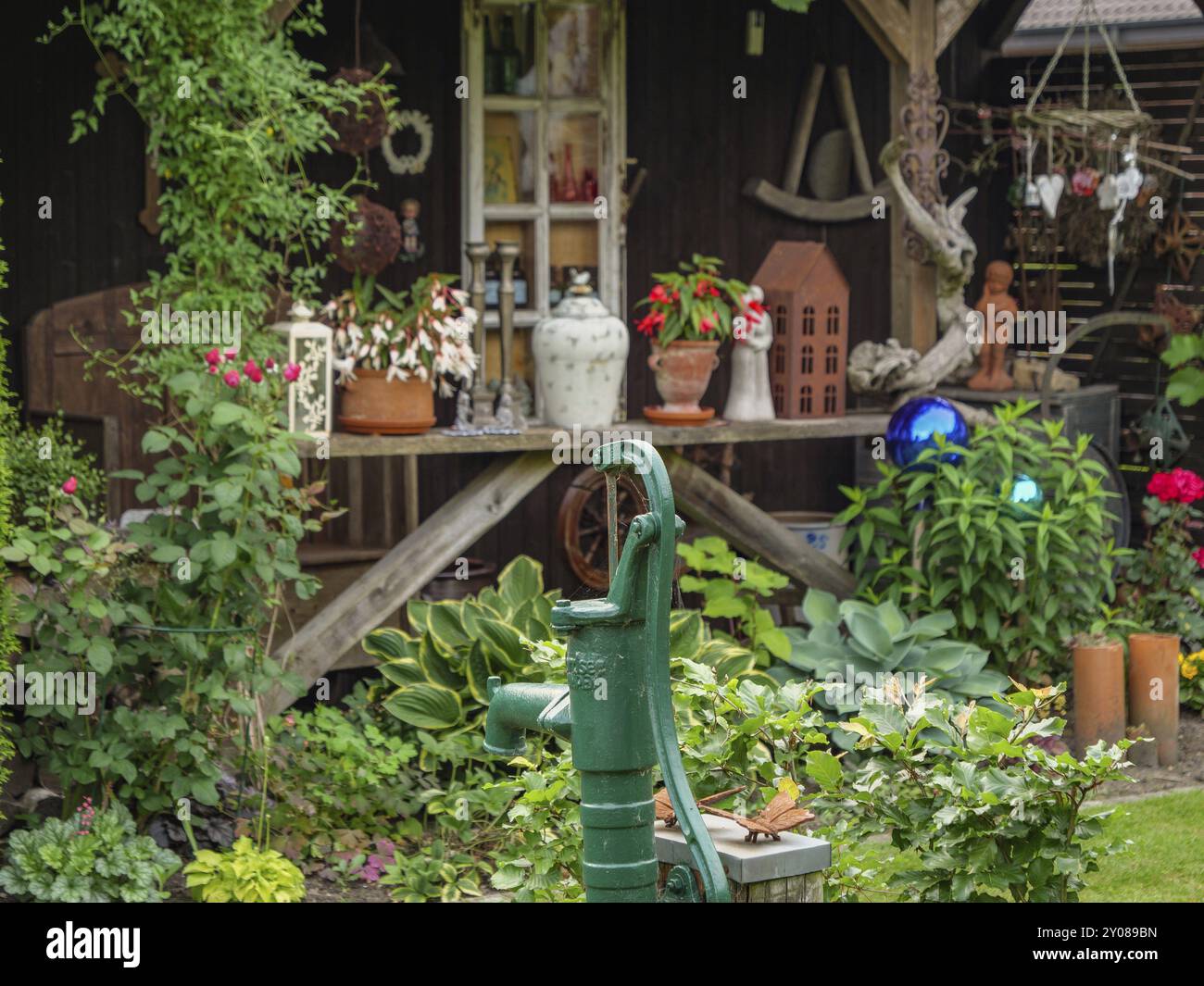 Rustic garden scene with various plant decorations and antique objects ...