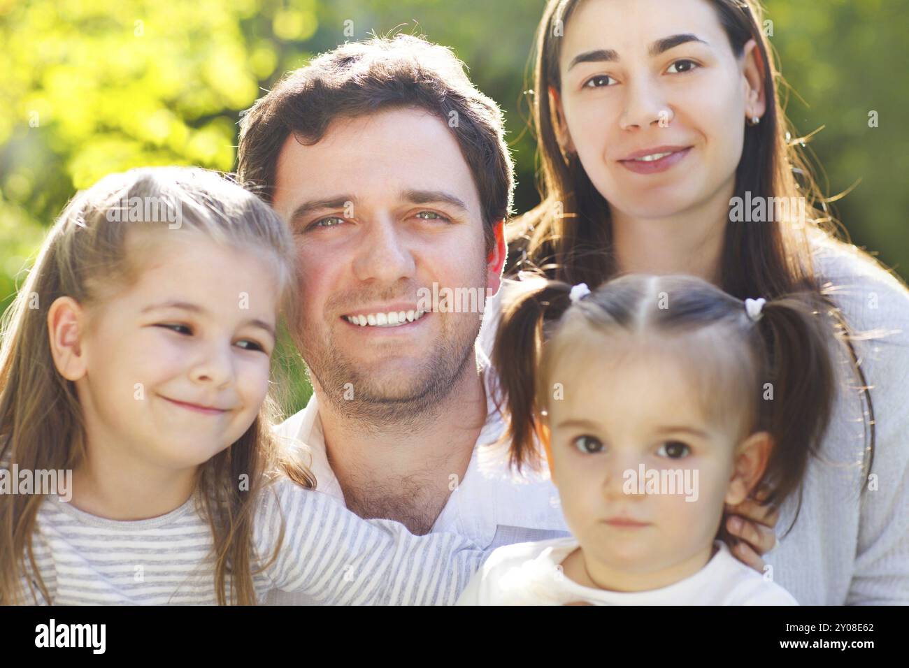 Happy young family with two children outdoors Stock Photo - Alamy