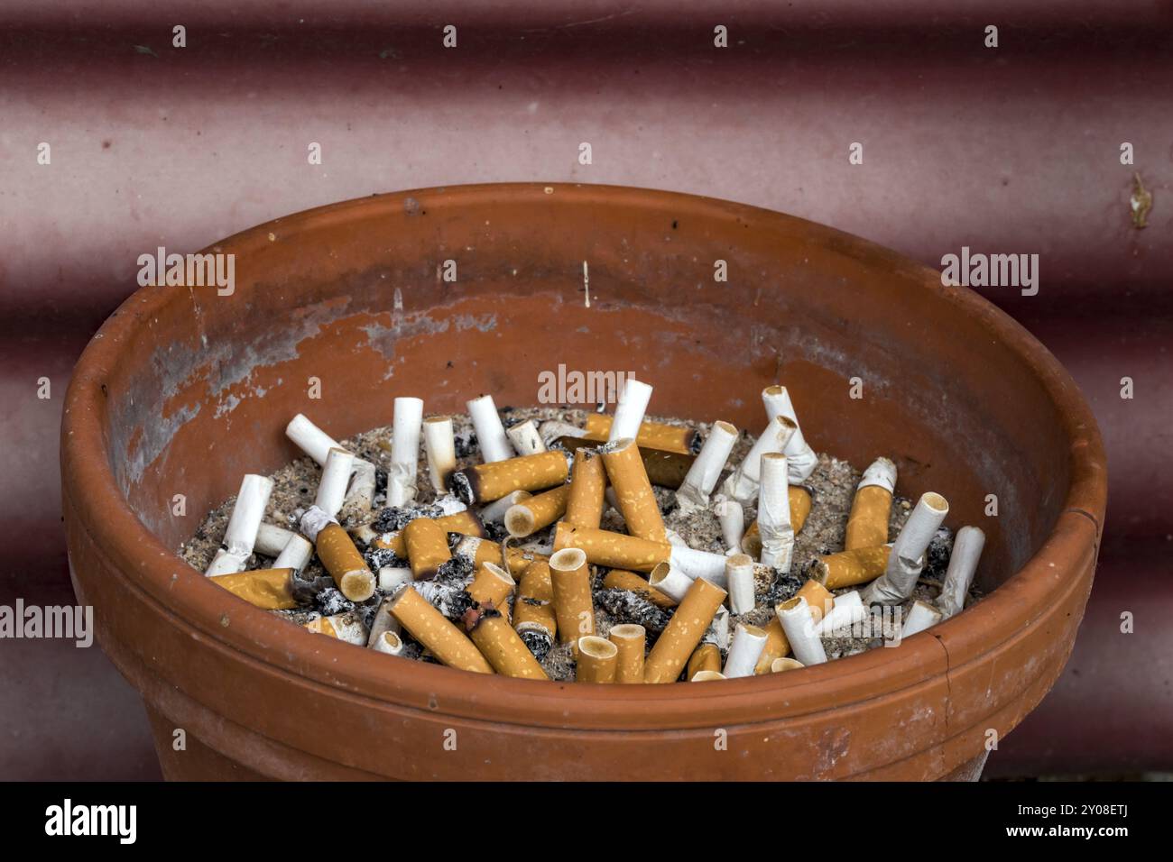 Cigarette ashtray Ashtray filled with sand Stock Photo - Alamy