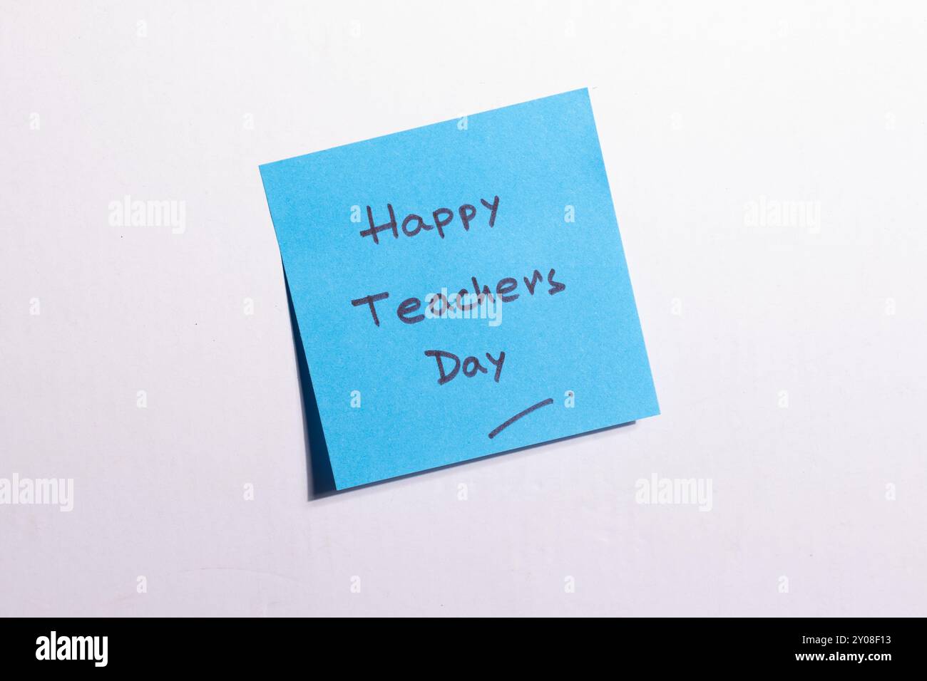 A blue sticky note showing happy teachers day on white background Stock ...