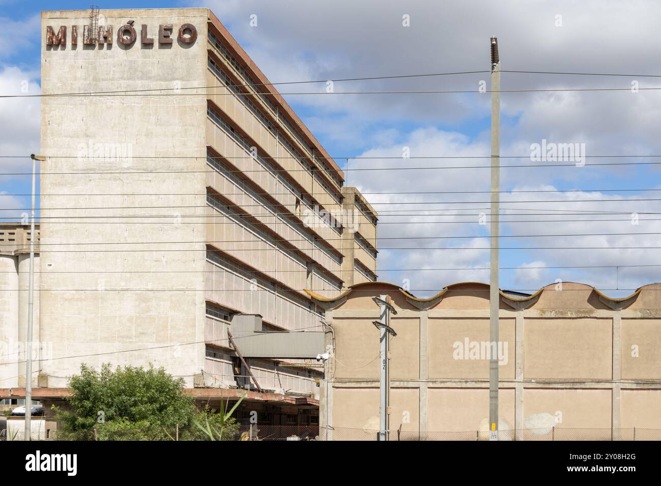 Old, abandoned factory building with the name milholeo still visible on ...