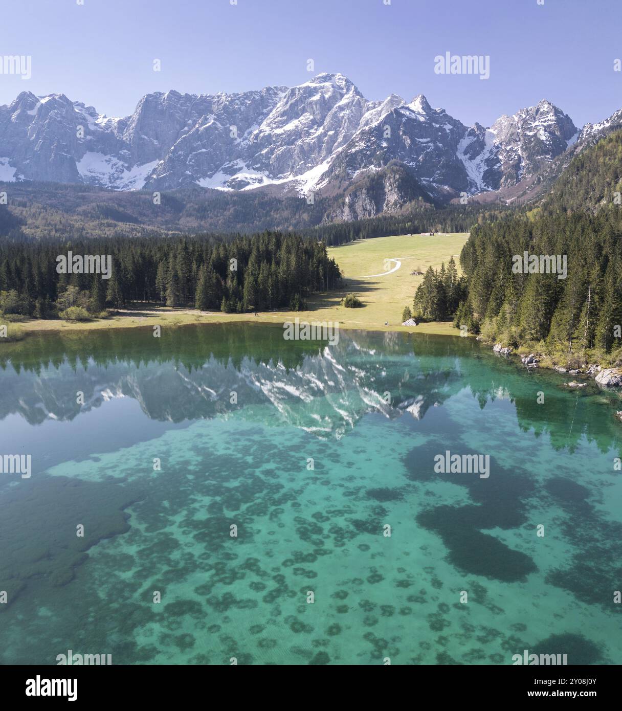 Aerial view of Lake Fusine and the Mangart mountain range, Tarvisio ...