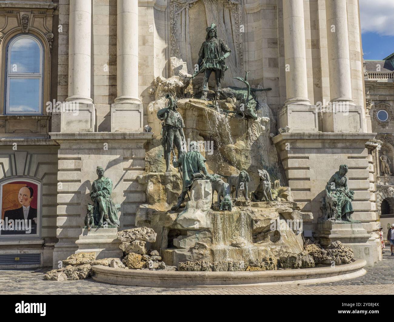 A fountain with historical statues in front of an impressive castle ...