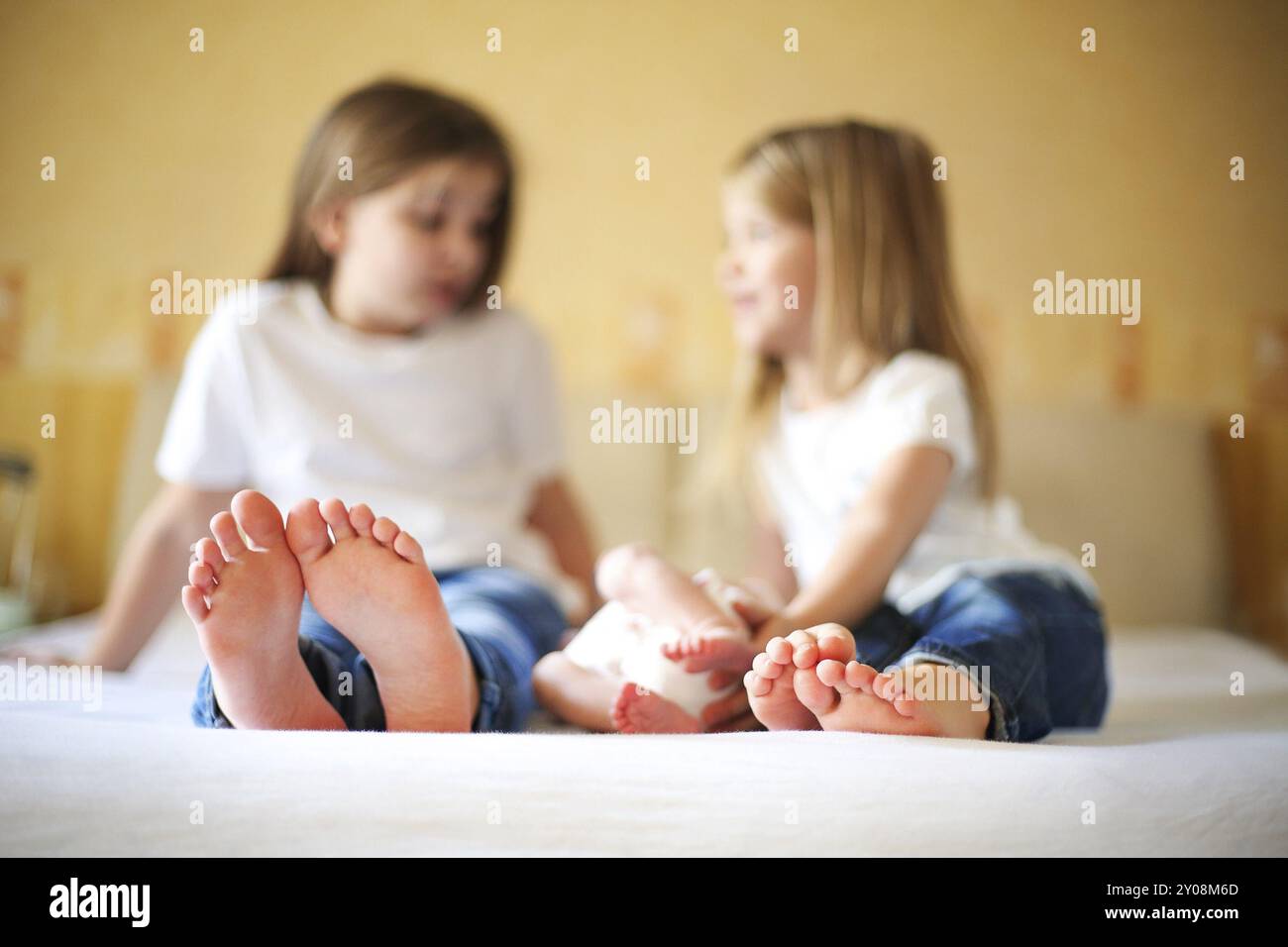 Sweet family in bed. Three sisters, close up on feet. Love and ...