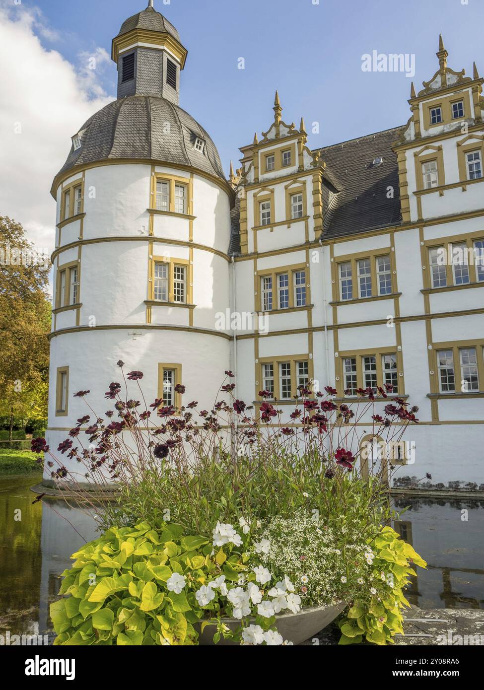 Baroque castle with tower and beautiful garden full of flowers on the ...