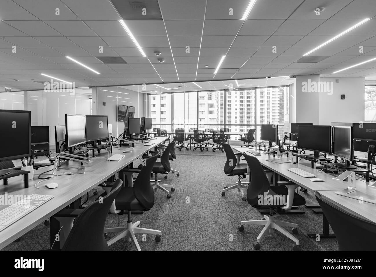 Stylish office interior with chairs, pc computers and table in row near ...