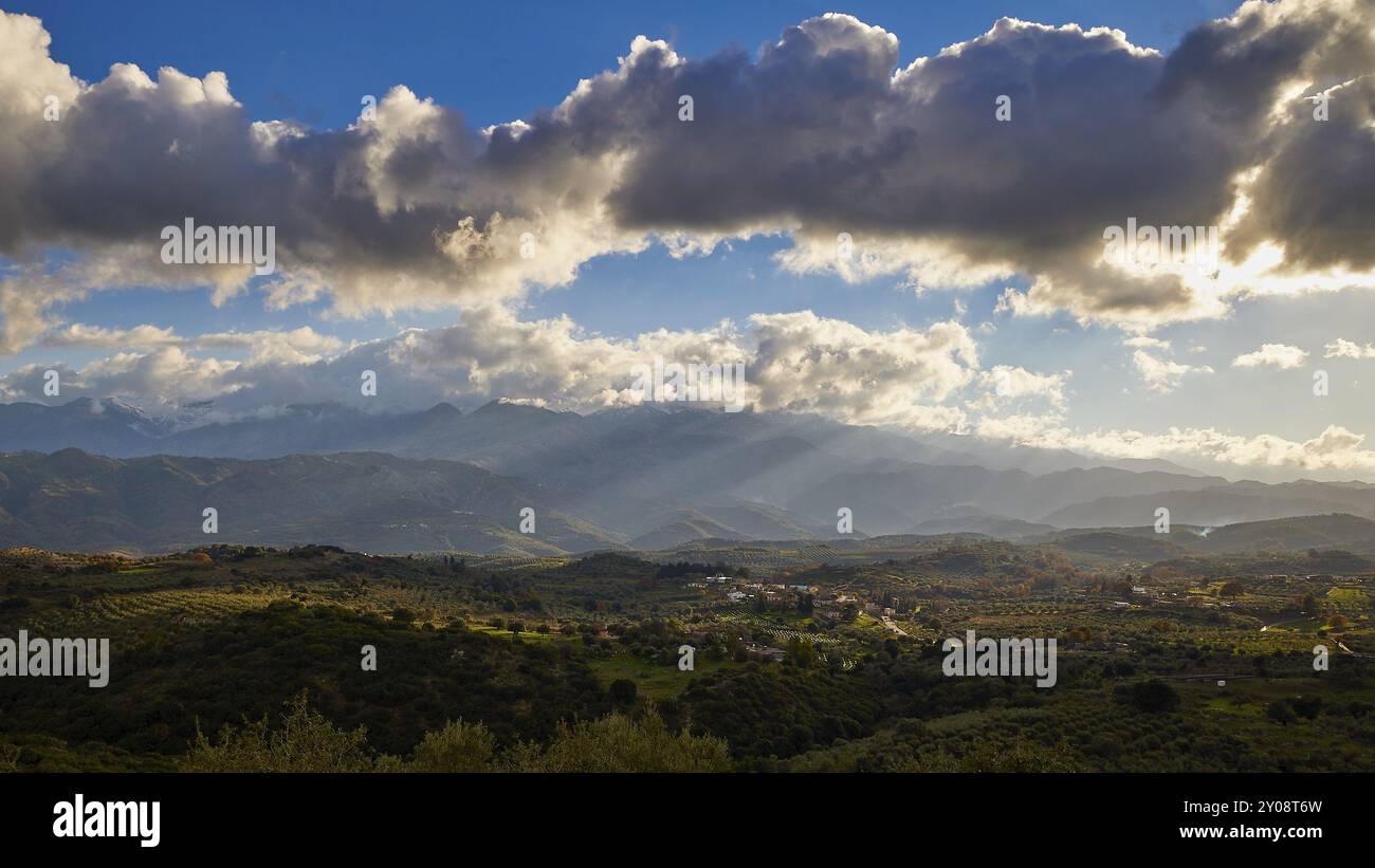 Green landscape with hills under a sunny sky with clouds, Lefka Ori ...