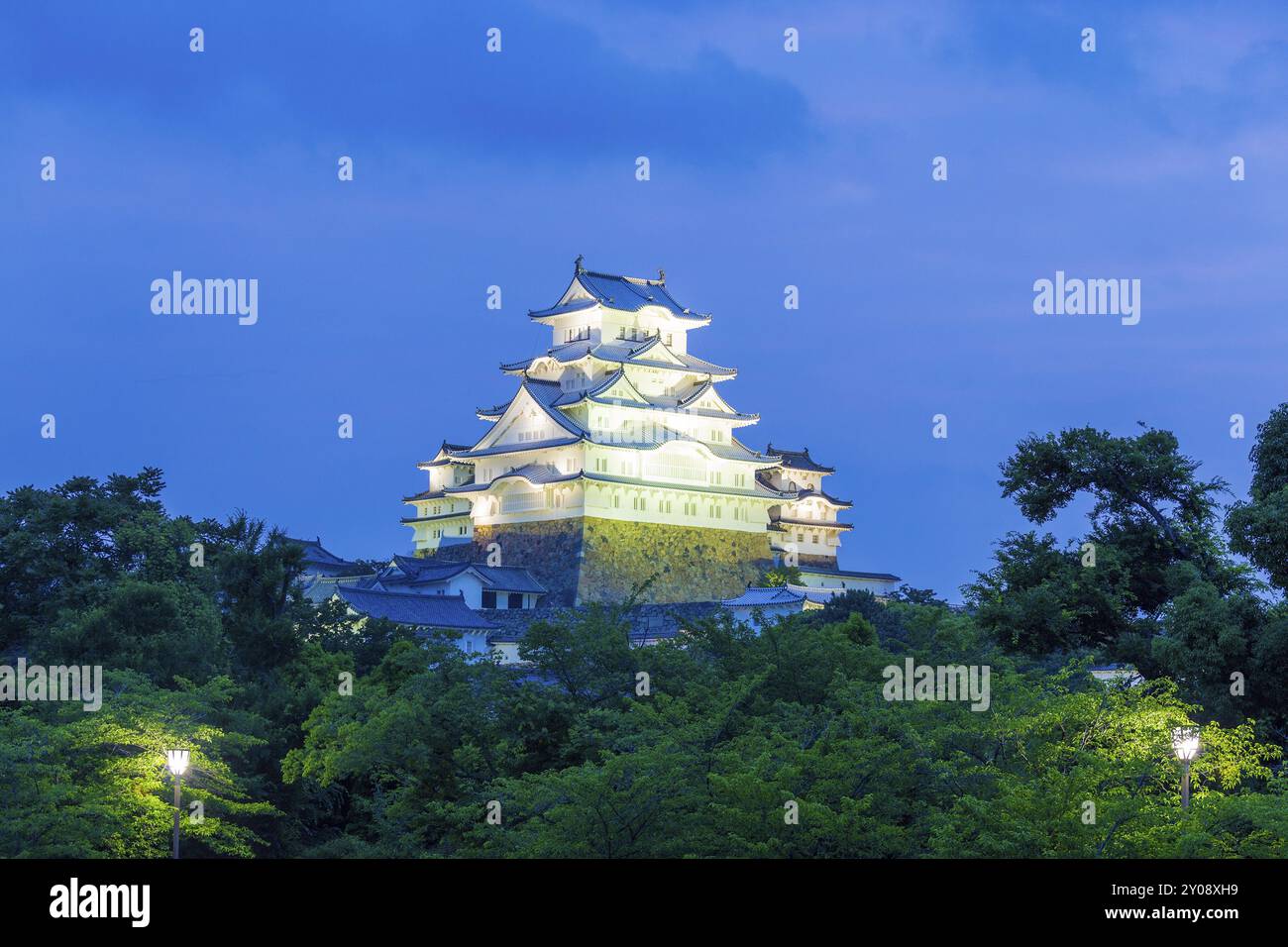 Colorful sunset sky behind ancient Himeji-jo castle rising above ...